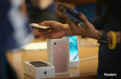 Apple iPhone sales fall but beat estimates; shares slip